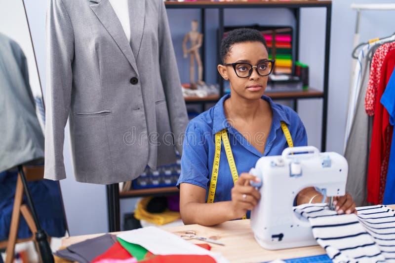African American Woman Tailor Using Sewing Machine at Tailor Shop Stock ...