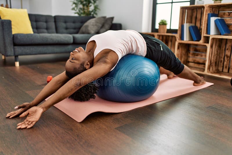 African American Woman Training Abs Exercise Using Fit Ball at Home ...