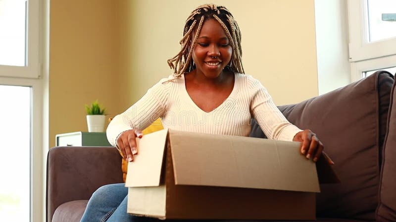 African American Woman Unpacking Things in a Box Stock Video - Video of ...
