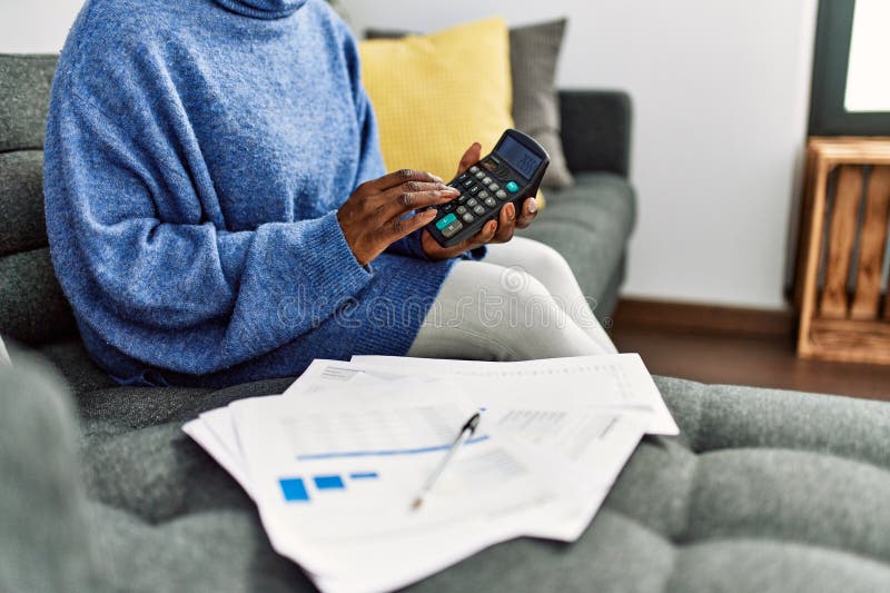 African American Woman Using Calculator Accounting at Home Stock Photo ...