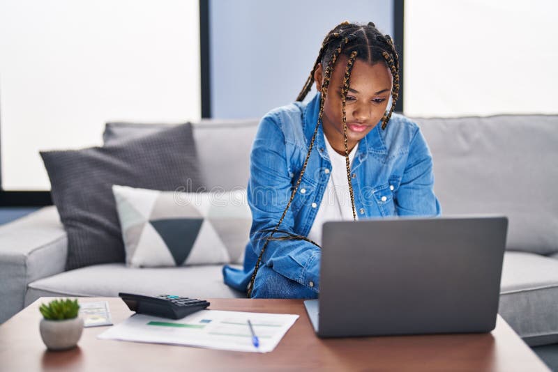 African American Woman Using Laptop Accounting at Home Stock Photo ...