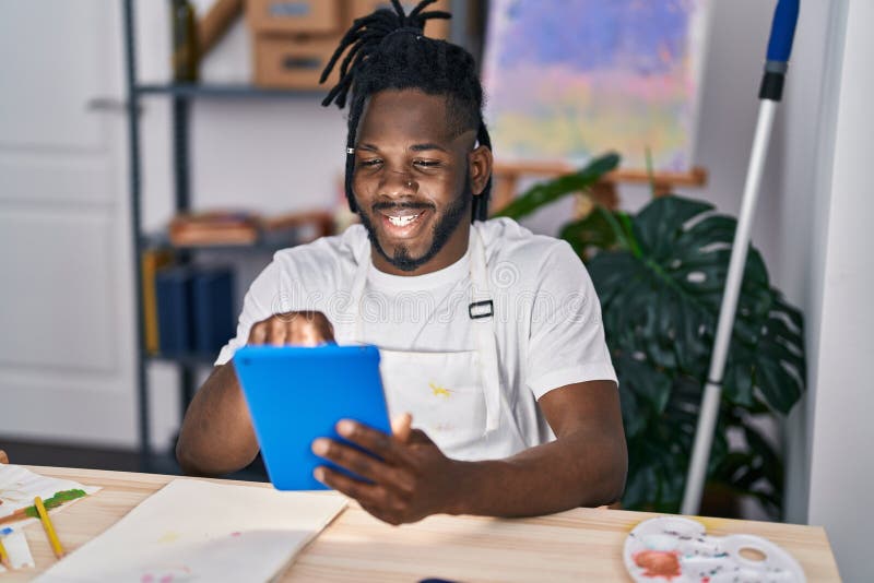 African American Woman Using Touchpad Drawing on Notebook at Art Studio ...
