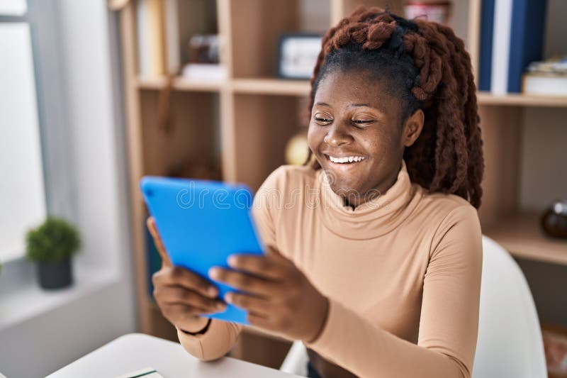 African American Woman Using Touchpad Sitting on Table at Home Stock ...