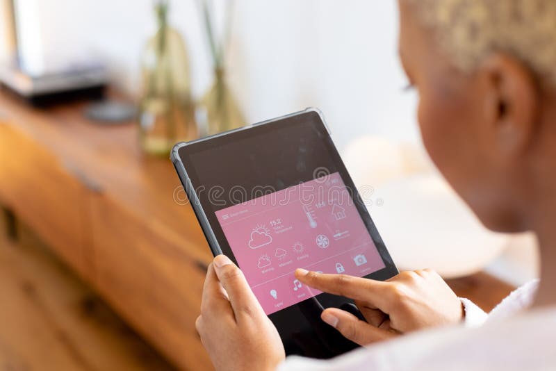 African American Woman Using Using Tablet with Smart Home Interface ...