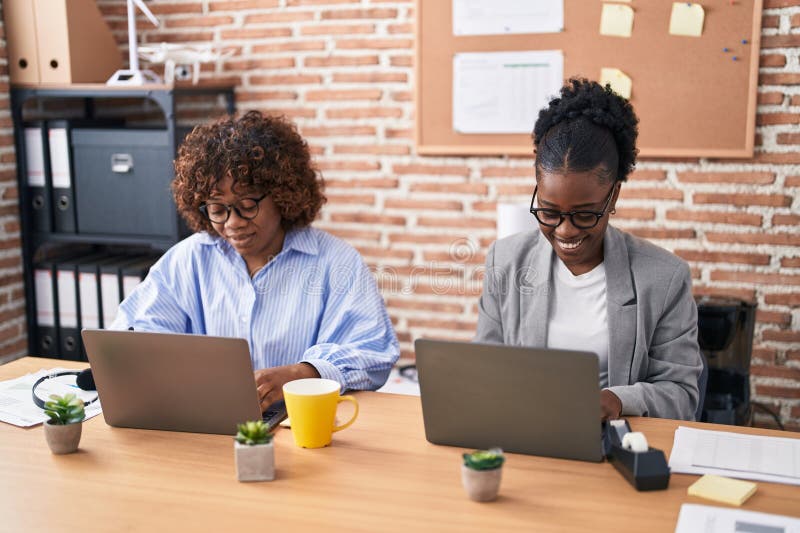 African American Women Business Workers Using Laptop Working at Office ...