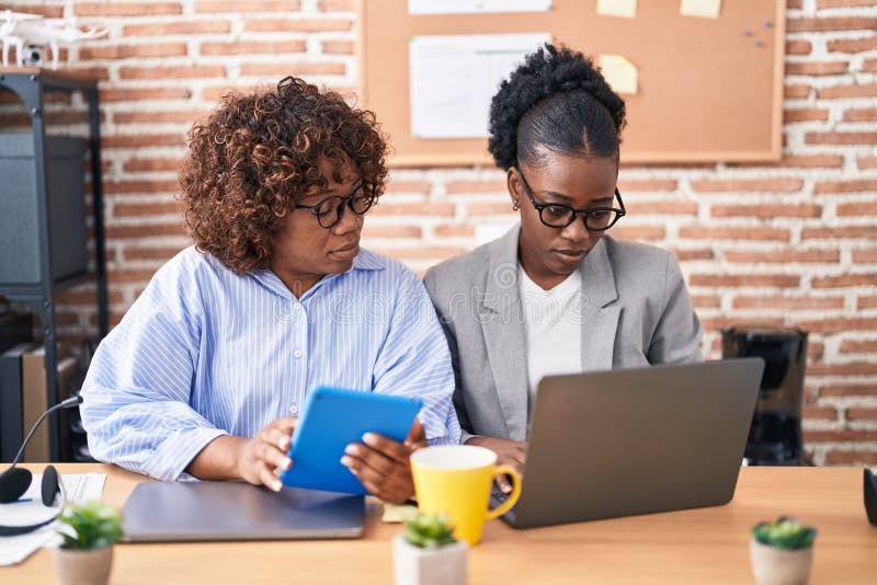 African American Women Business Workers Using Touchpad Working at ...