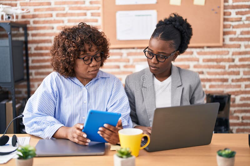 African American Women Business Workers Using Touchpad Working at ...