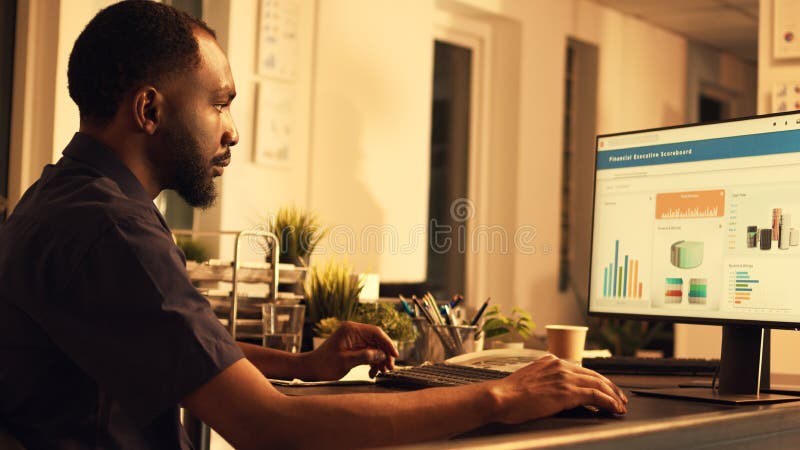African American Worker Analyzing Company Data on Computer Stock Photo ...