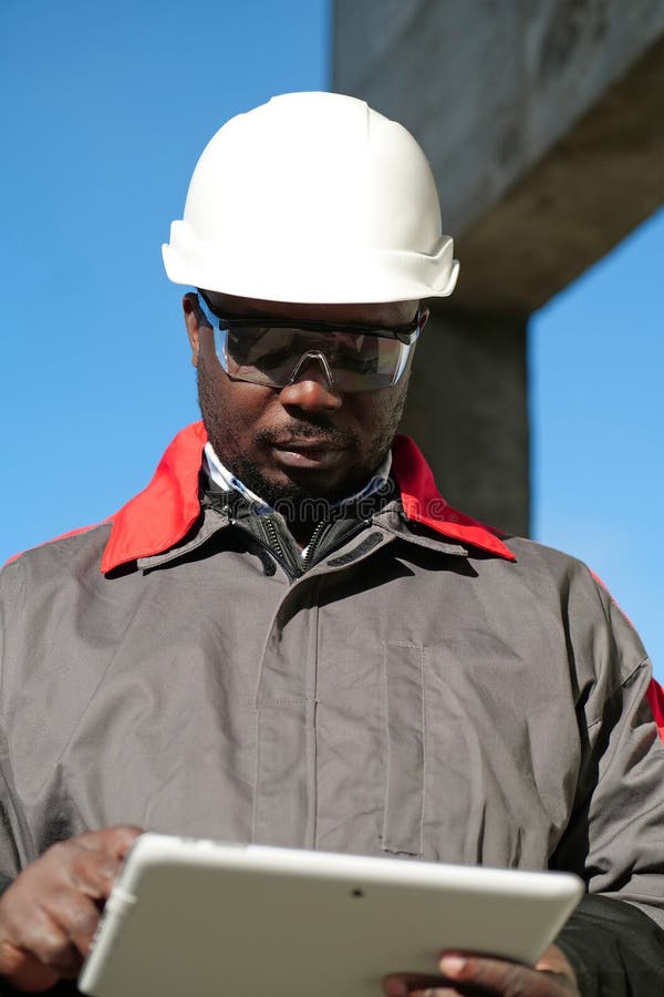 African American Worker with Tablet Computer Stands at Construction ...