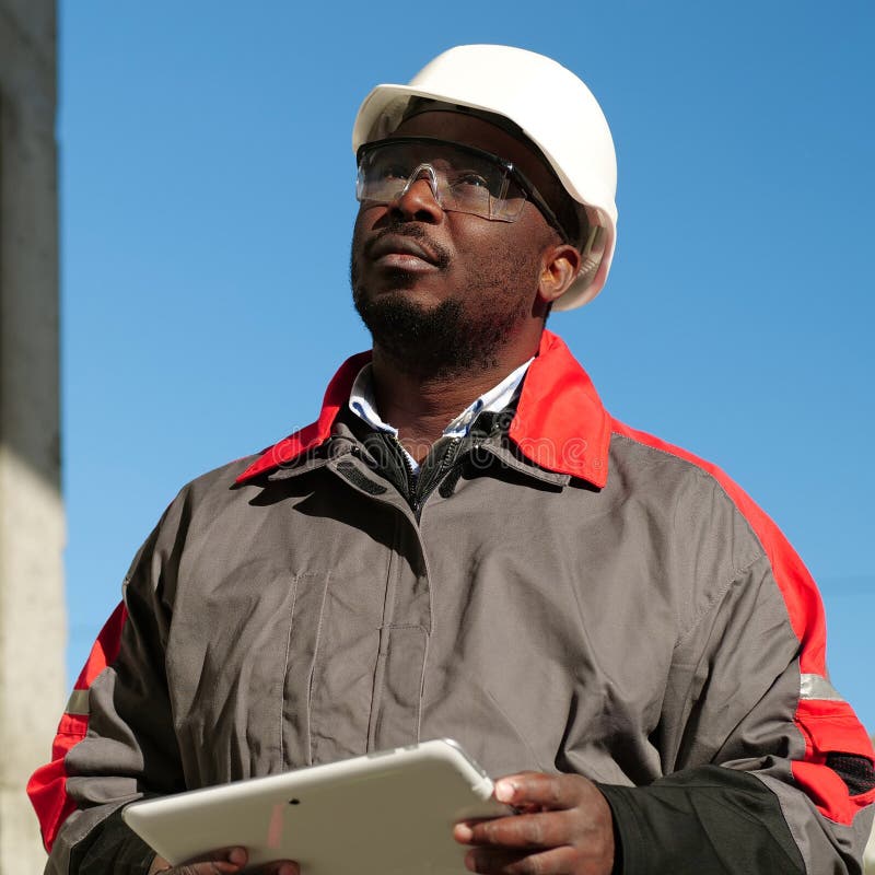 African American Worker with Tablet Computer Stands at Construction ...