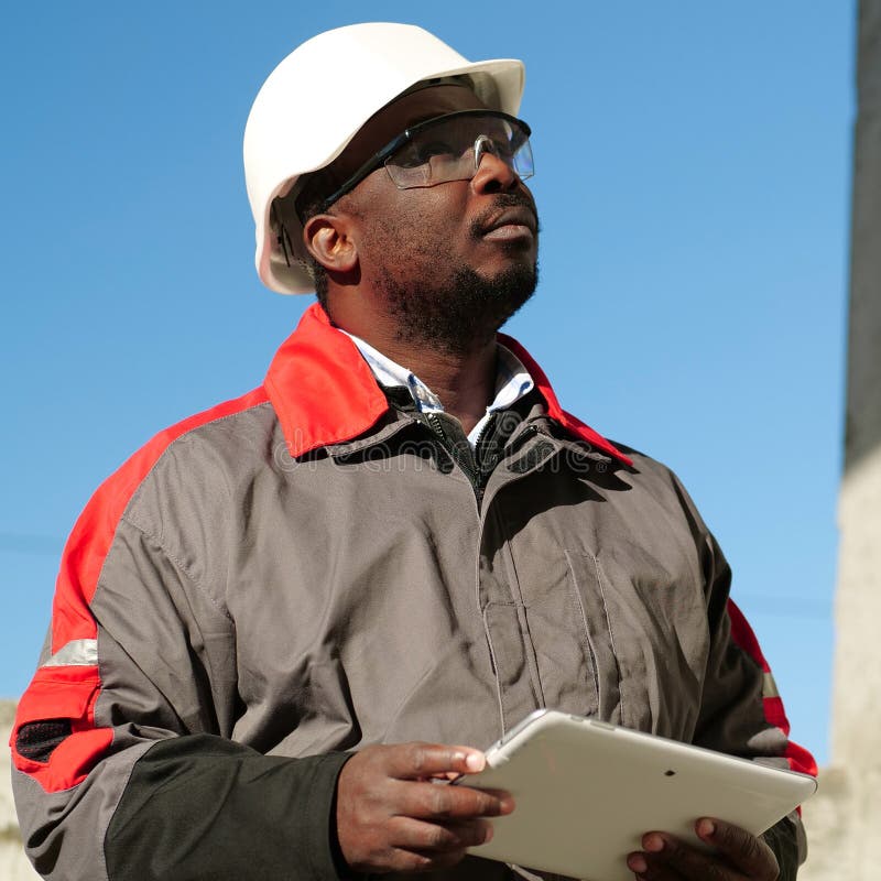 African American Worker with Tablet Computer Stands at Construction ...