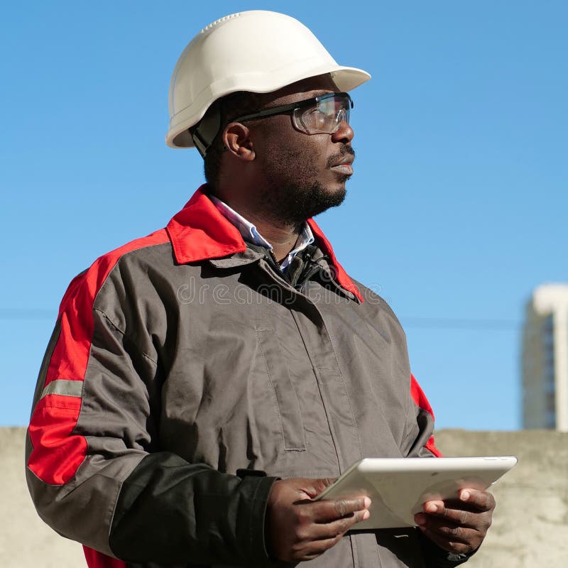 African American Worker with Tablet Computer Stands at Construction ...