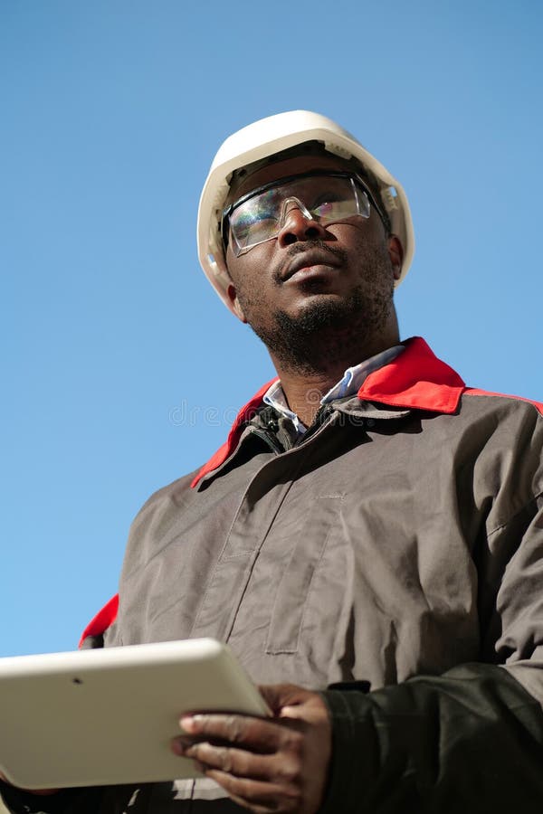 African American Worker with Tablet Computer Stands at Construction ...