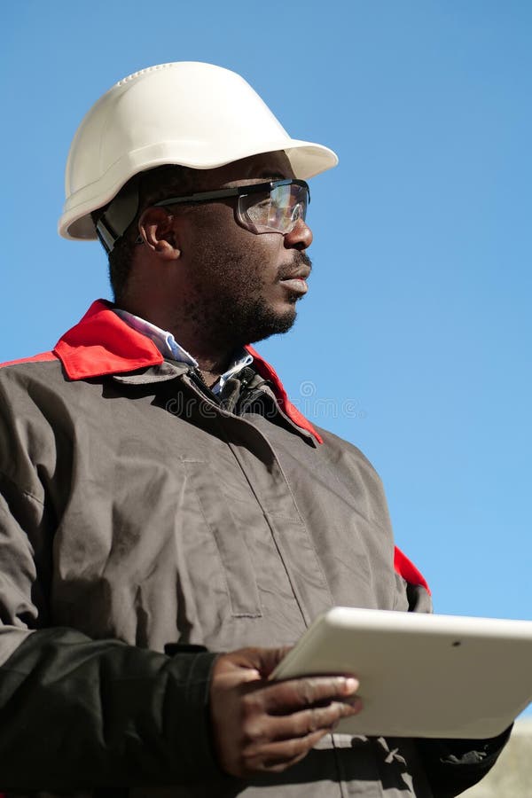 African American Worker with Tablet Computer Stands at Construction ...