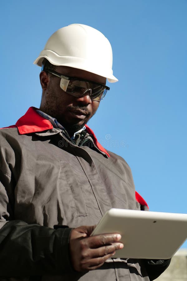 African American Worker with Tablet Computer Stands at Construction ...