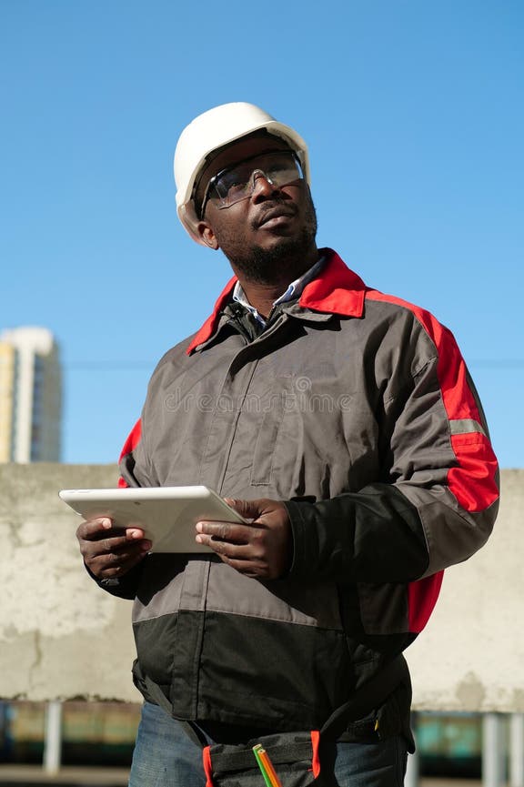 African American Worker with Tablet Computer Stands at Construction ...