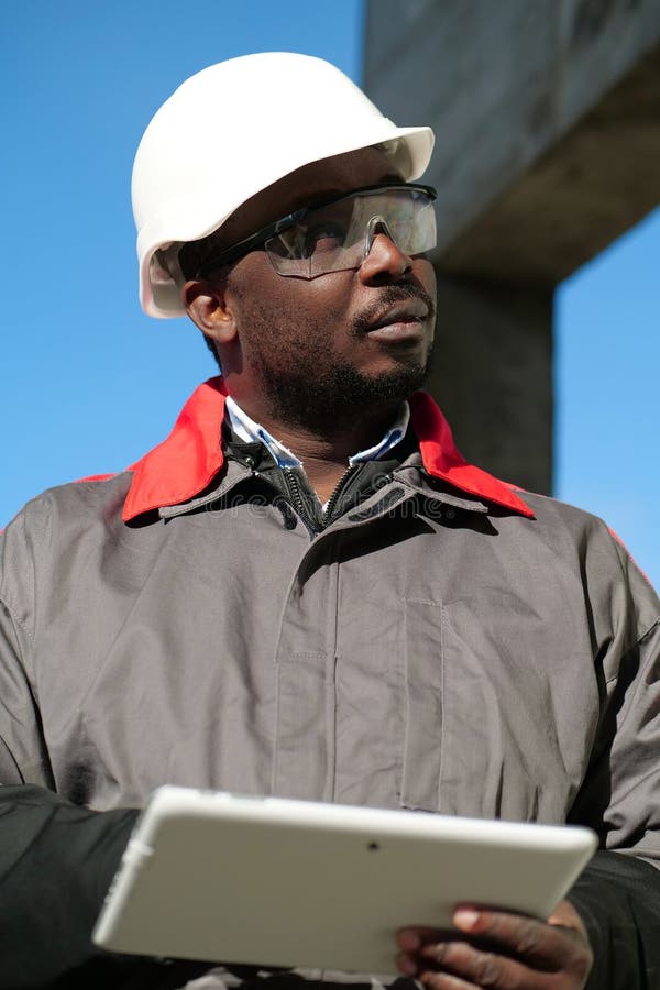 African American Worker with Tablet Computer Stands at Construction ...