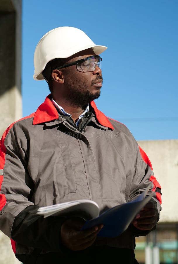 African American Workman with Smartphone at Construction Site Stock ...