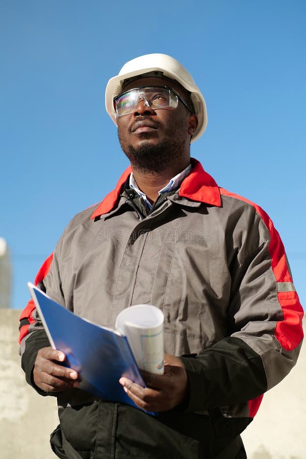 African American Workman with Smartphone at Construction Site Stock ...