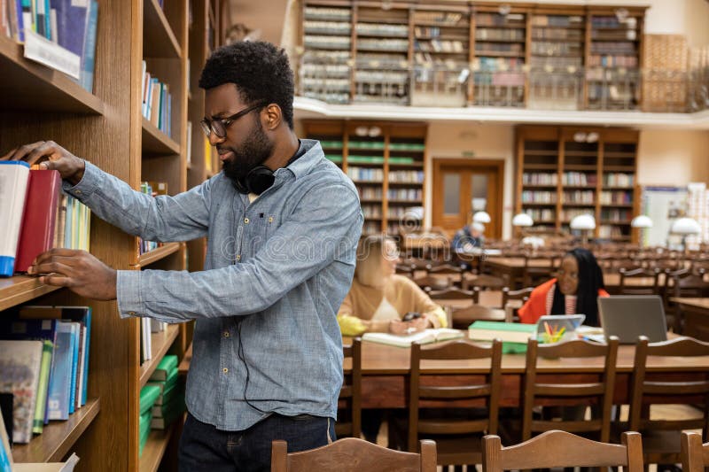 African American Young Man in the Library Looking Busy and Involved ...