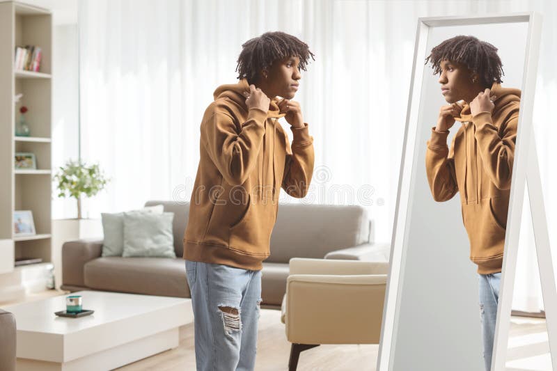African American Young Man Standing in Front of a Mirror Stock Photo ...