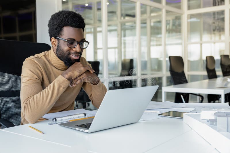African American Young Man Working in the Office and Looking Busy Stock ...