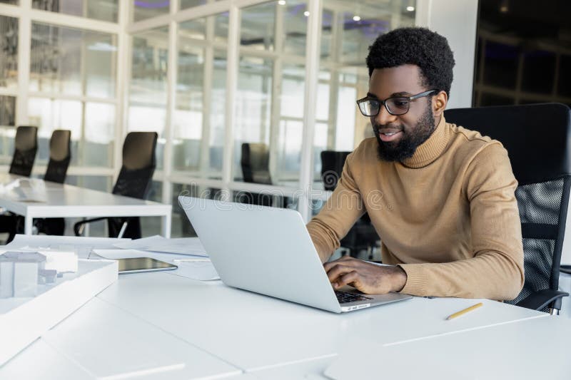 African American Young Man Working in the Office and Looking Busy Stock ...
