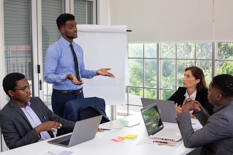 Group of Business People Listening To Colleague Addressing Office ...