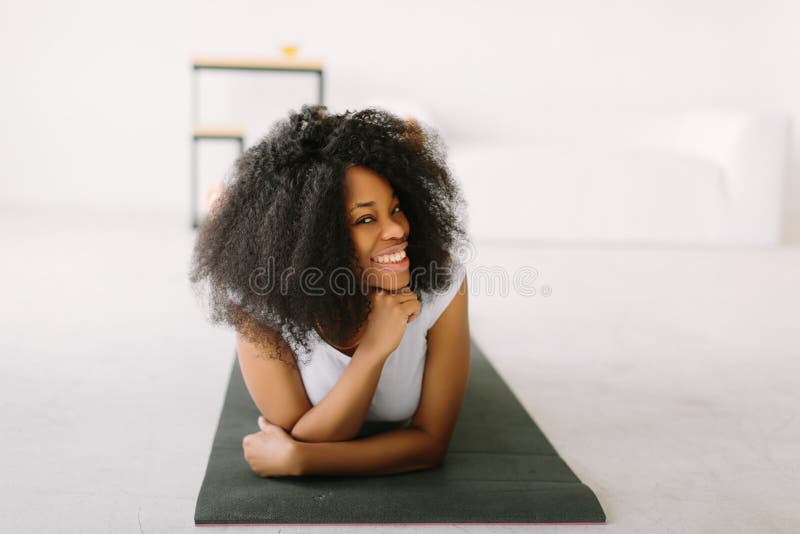 An African American Young Woman Jumping on White Bed Stock Image ...