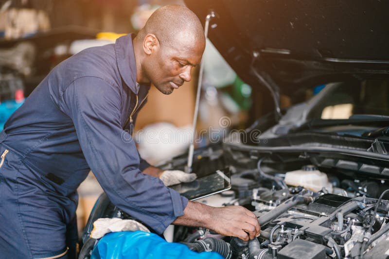 African Black Man Car Service Focus at Work. Mechanic Working in Garage Workshop Maintenance ...