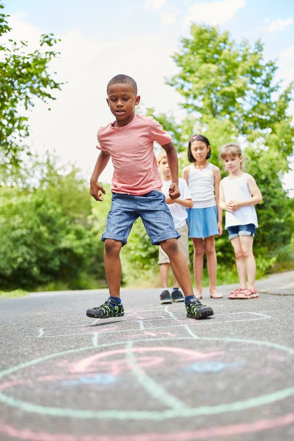 African Boy Playing Hopscotch with Friends Stock Photo - Image of ...