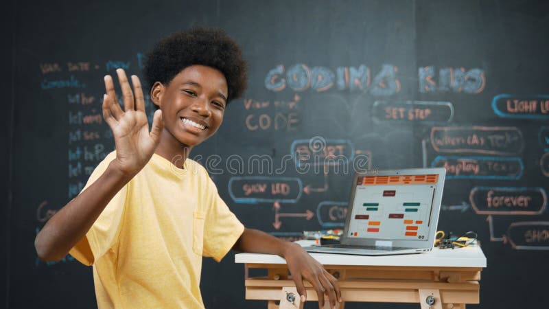 African Boy Use Laptop To Code Program and Turn Around To Wave Hand ...