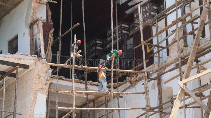 African Builders Reconstruct Crumbling Building in Stone Town, Zanzibar ...