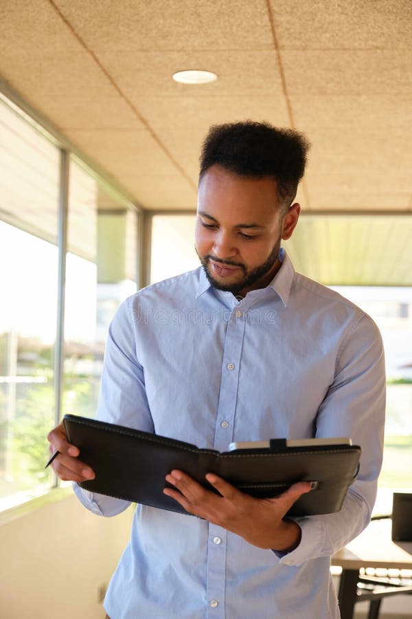 African Business Man Analyzing a Report at a Coworking. Stock Photo ...