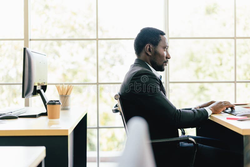 The African Businessman Typing Keyboard and Looking on the Screen with ...
