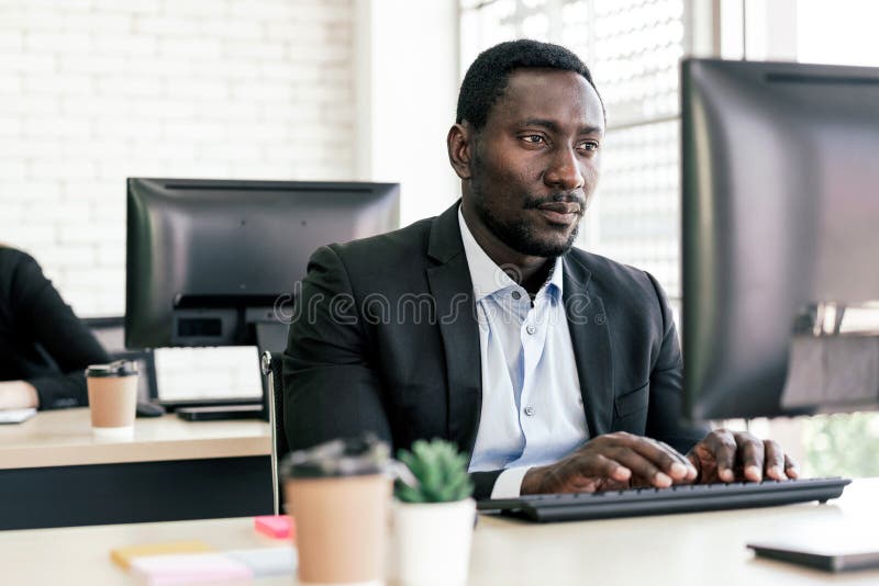 The African Businessman Typing Keyboard and Looking on the Screen with ...