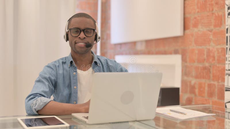 African Call Center Man with Headphones Smiling at Camera at Work Stock ...