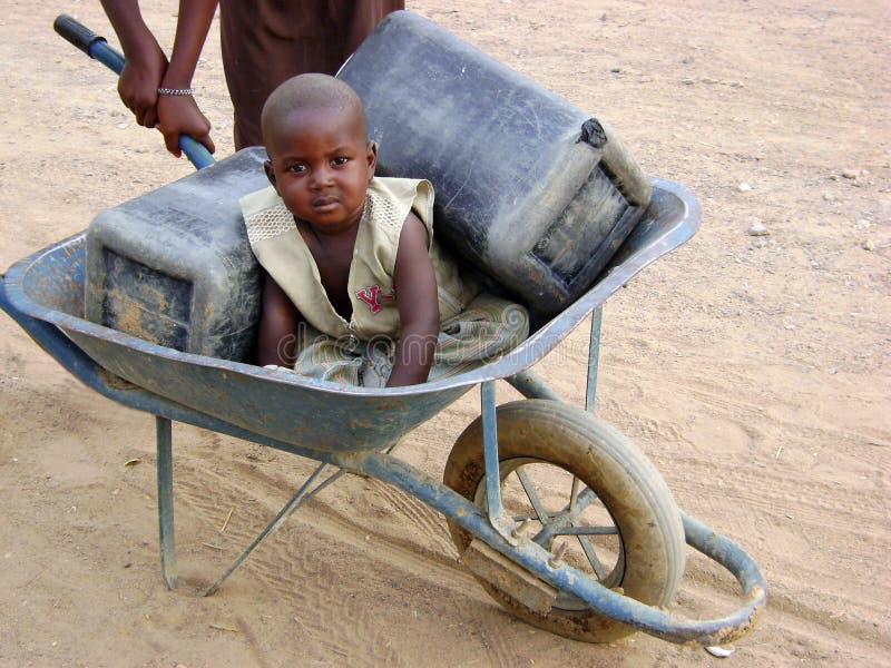 African Child in a Wheelbarrow Editorial Stock Image - Image of barrow ...