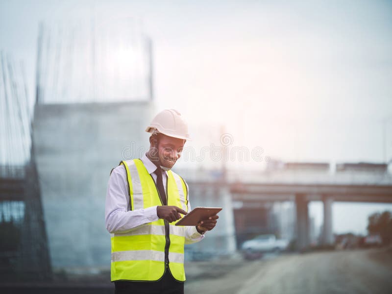 African Civil Engineer Working with Use Tablet for Control the Road ...