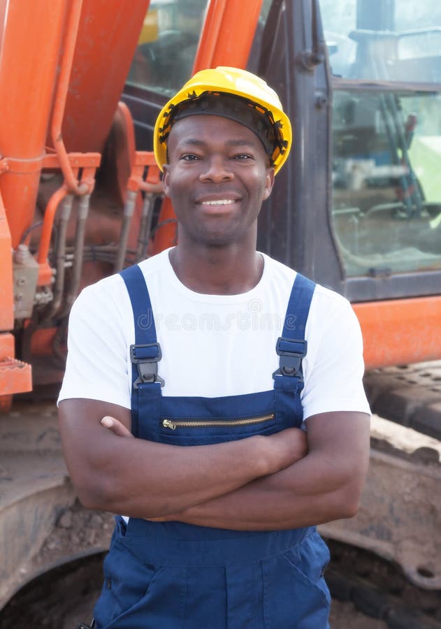 African Construction Worker with Crossed Arms and Red Excavator Stock ...