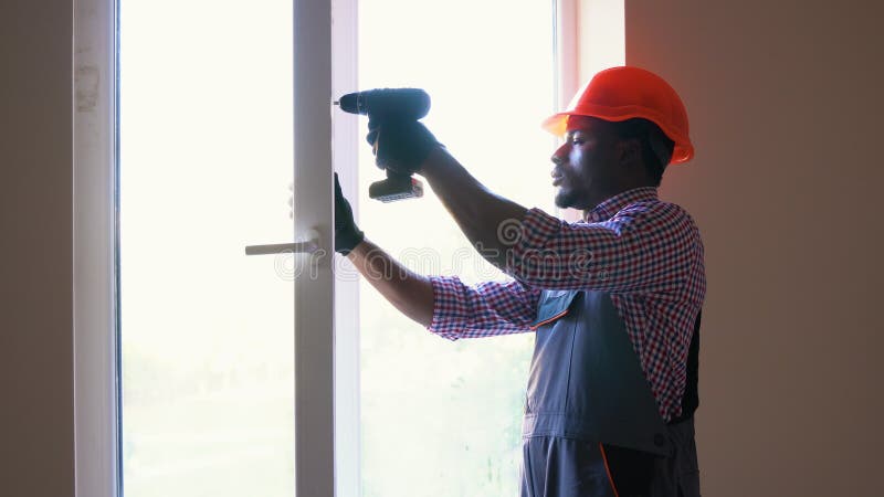 African Construction Worker Installing Pvc Window or Door in House ...