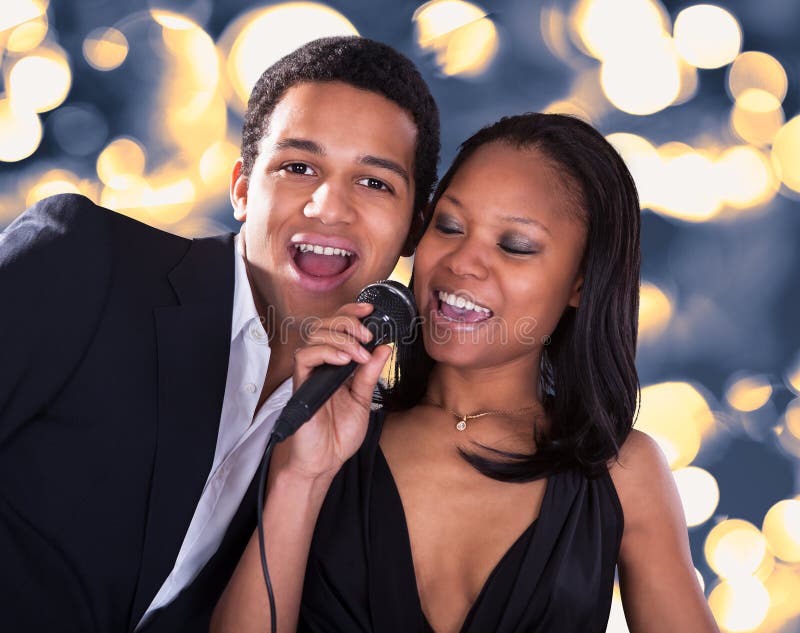 African Couple Singing with Microphone Stock Photo - Image of happiness ...