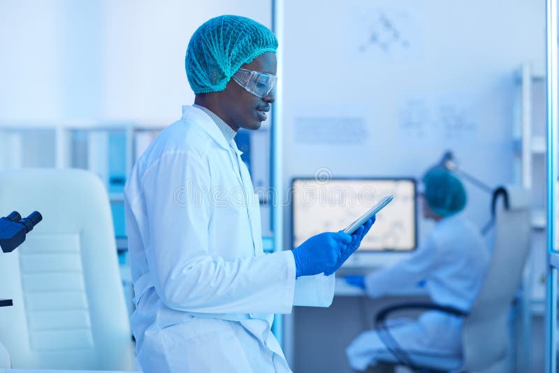 African Doctor Examining with Microscope Stock Photo - Image of looking ...