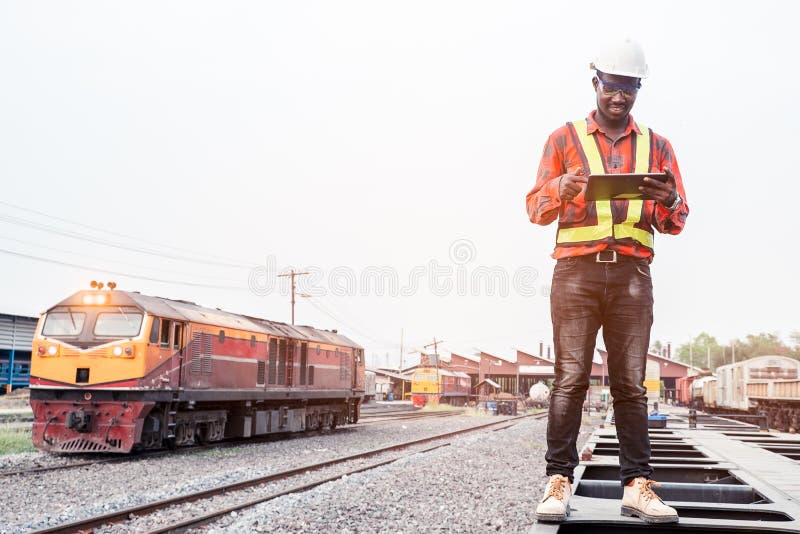 African Engineer Control a the Train on Railway with Using Tablet Stock ...