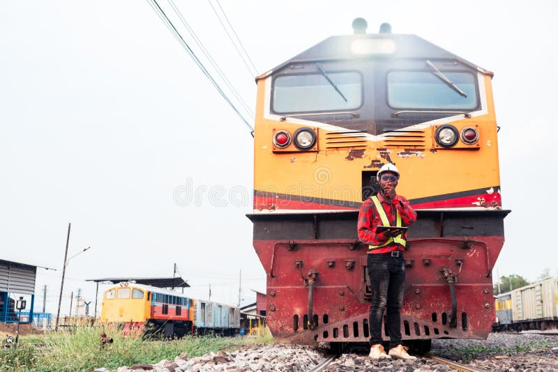 African Engineer Control a the Train on Railway with Using Tablet and ...