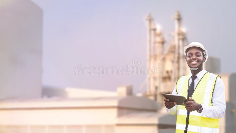 African Engineer Holding and Using Tablet Works at Factory.Engineering ...