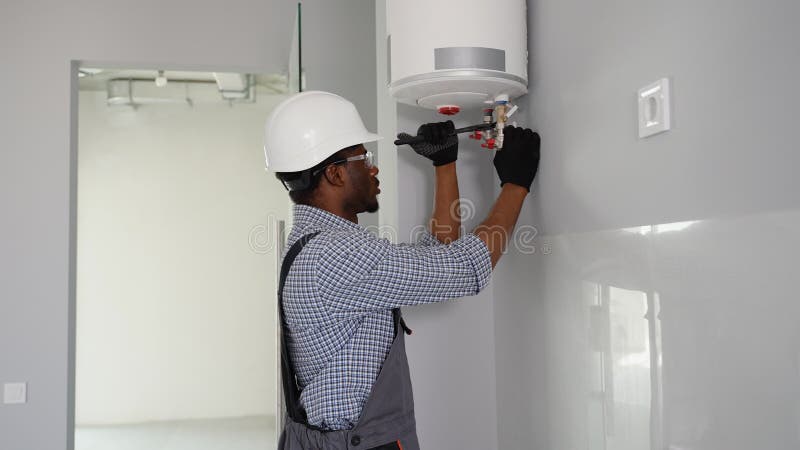 African Engineer Installing a Natural Gas Boiler at Home and Checking ...