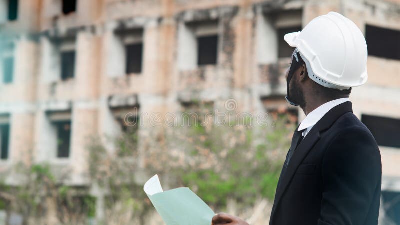 African Engineer Manager Checking Blueprint for Demolition Construction ...
