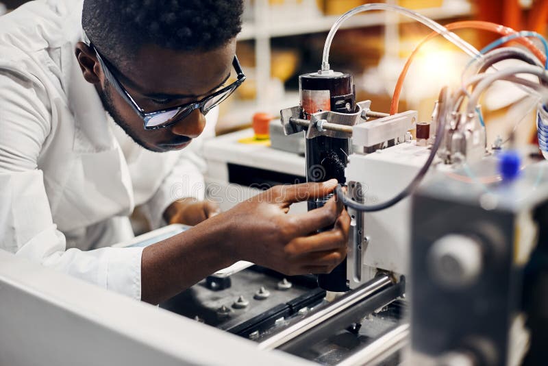 African Engineer Programming Equipment with Tablet at Factory Stock ...