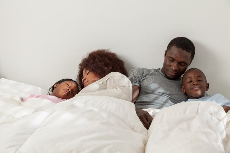 African Family Sleeping in the Bed Togehter Stock Photo - Image of four ...